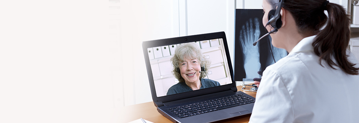 Doctor speaking to patient over computer